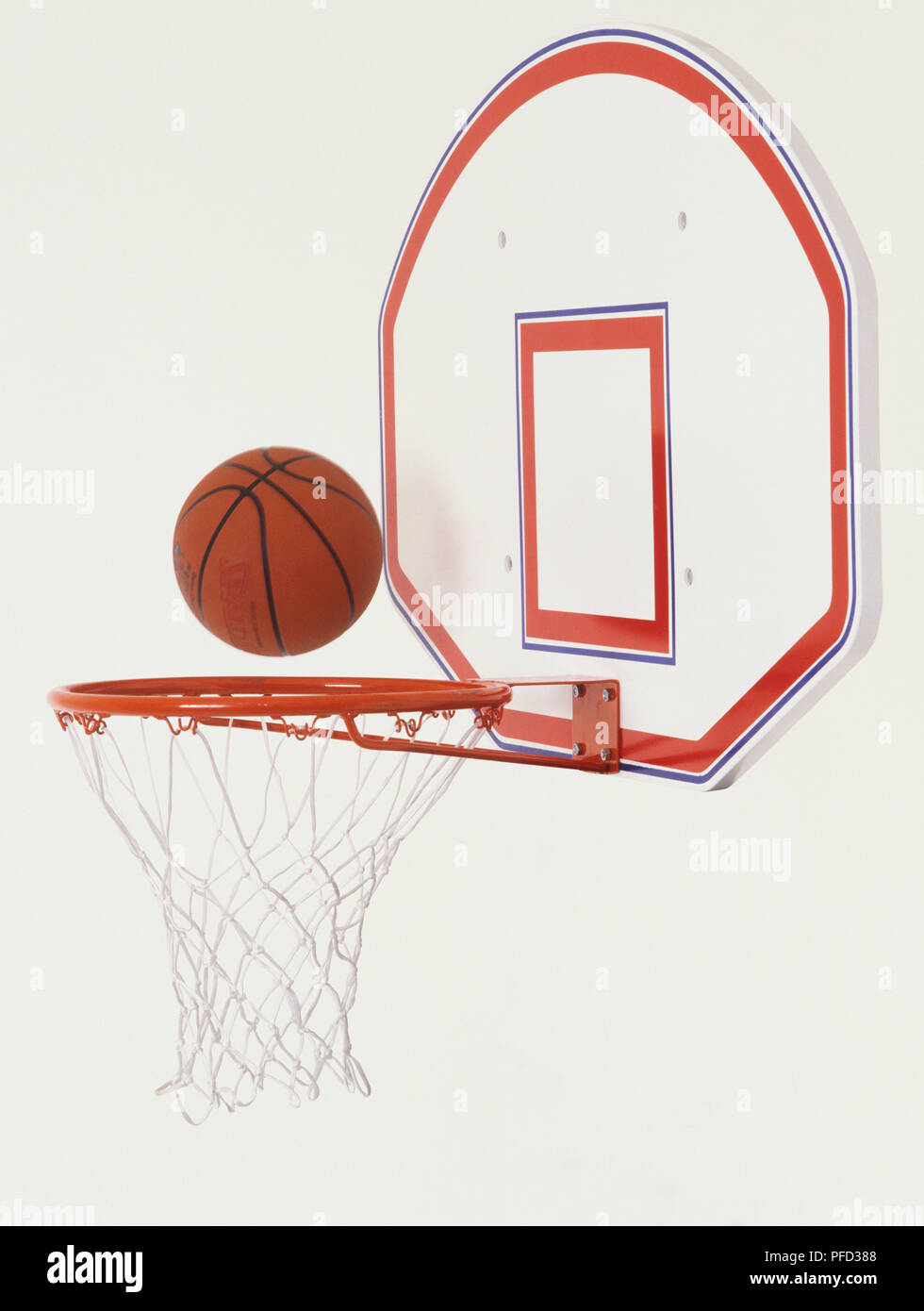 Basketball about to land in hoop Stock Photo - Alamy