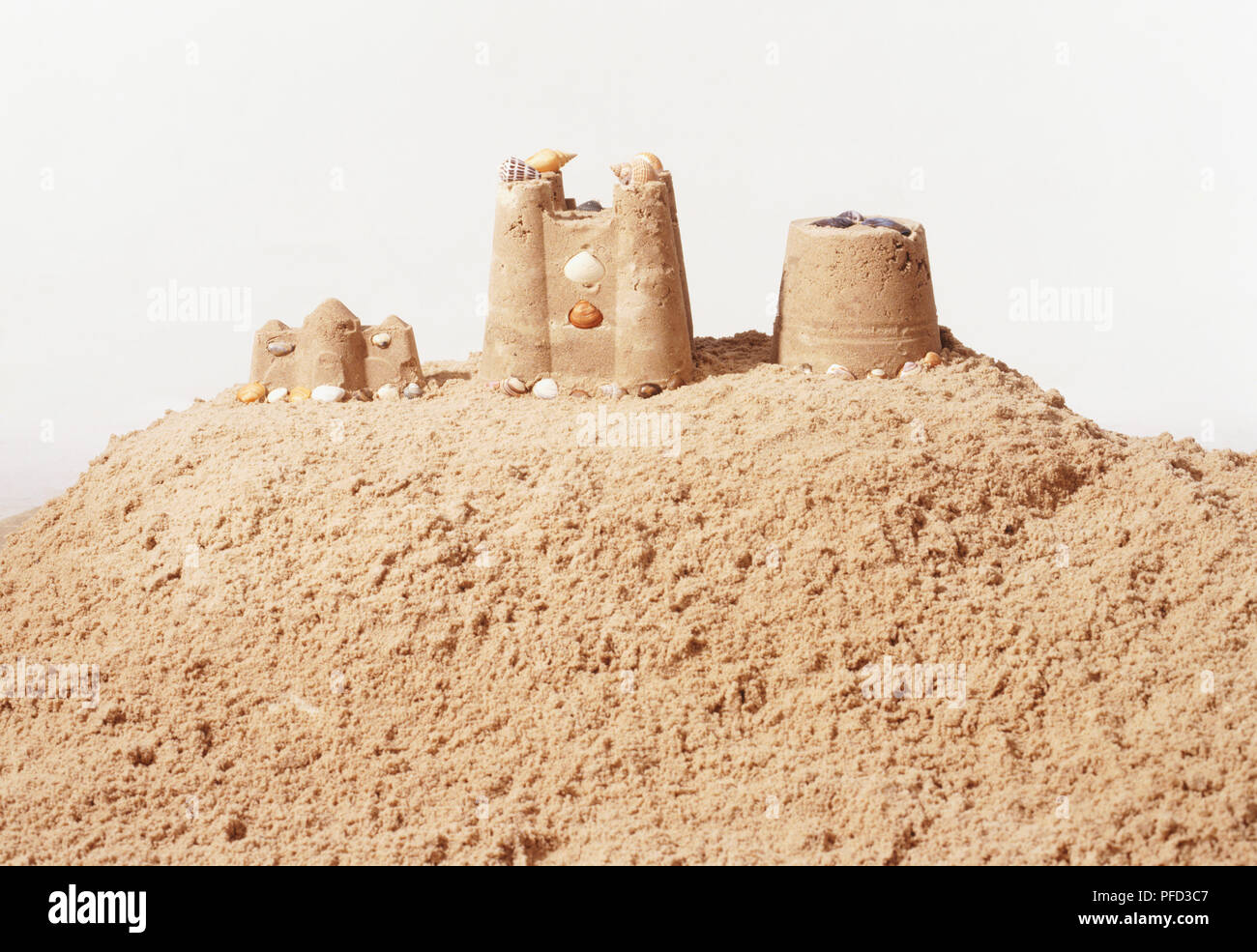 Sandcastle decorated with pebbles and shells Stock Photo - Alamy