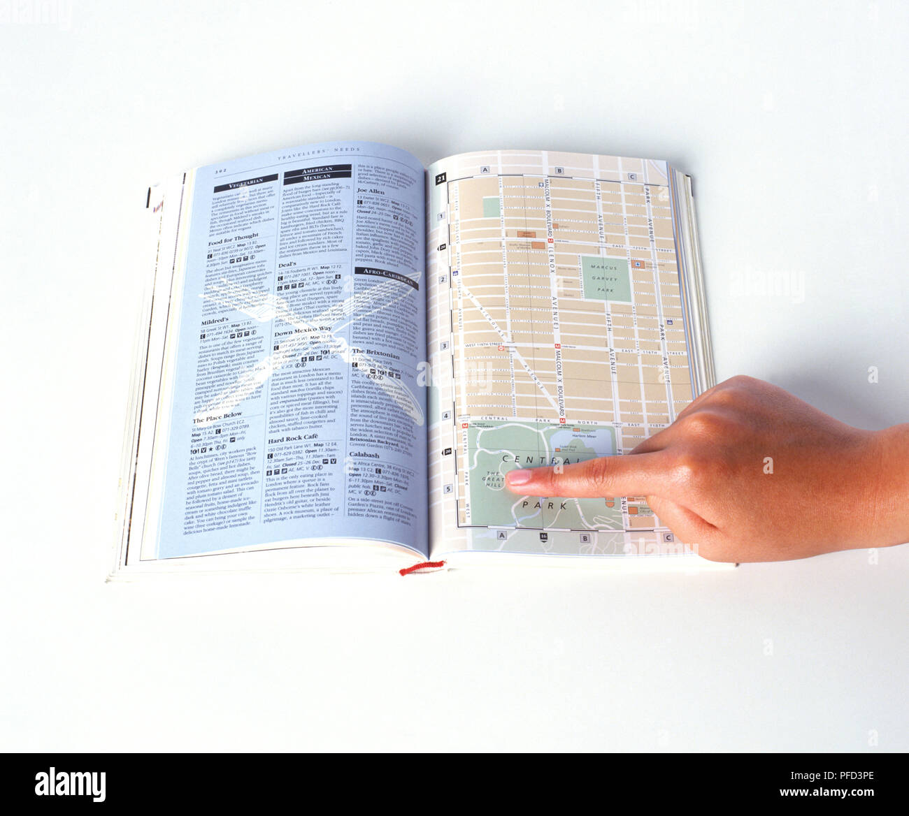 Hand pointing out spot in street guide Stock Photo - Alamy