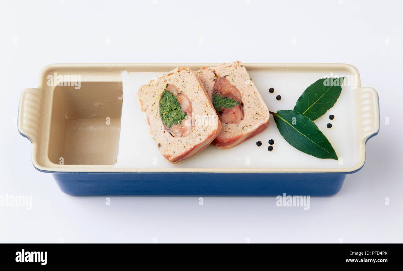 Quail and pheasant pate in pate terrine, with two slices, bay leaves ...