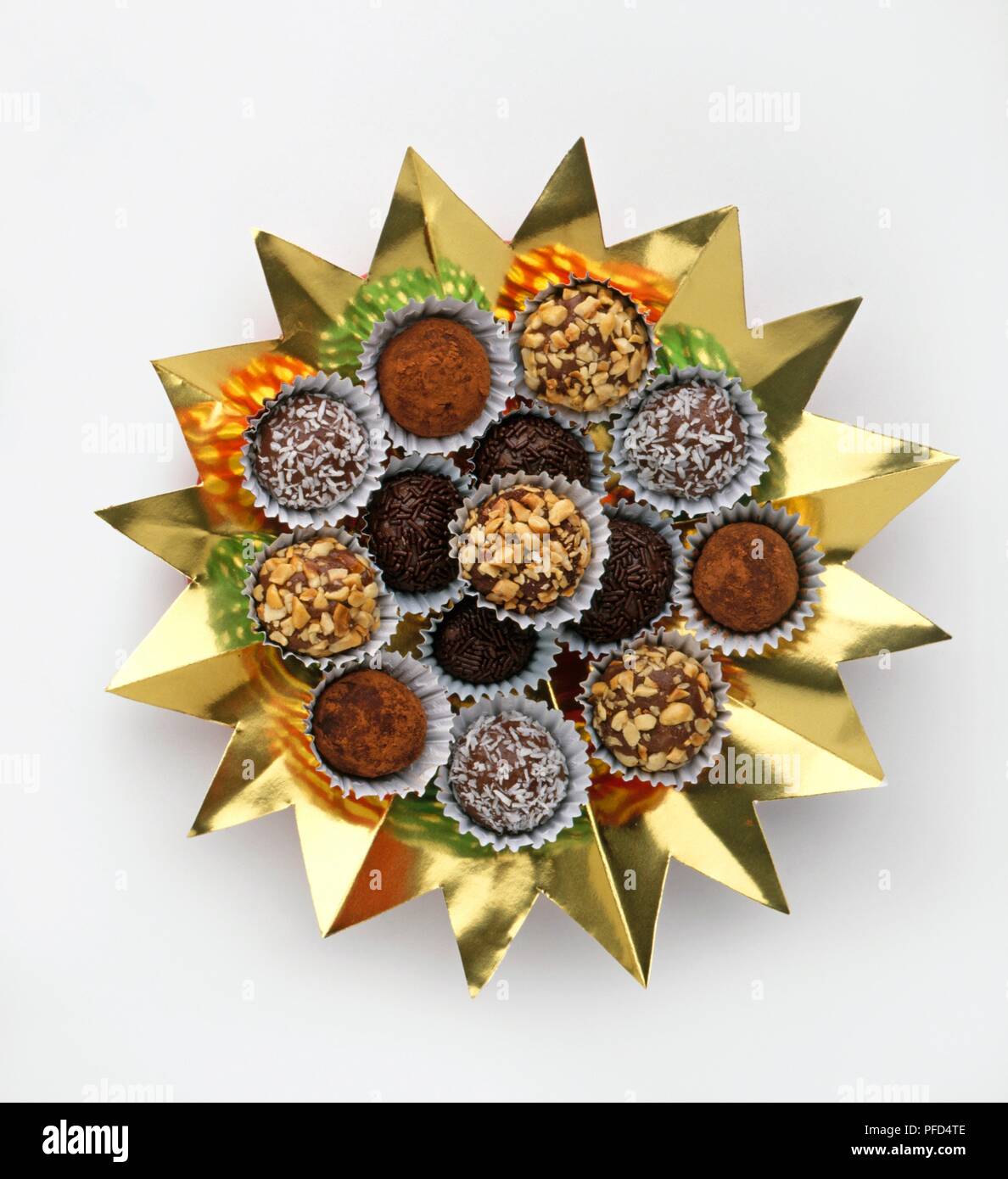 Selection of chocolate truffles on gold star-shaped tray Stock Photo ...
