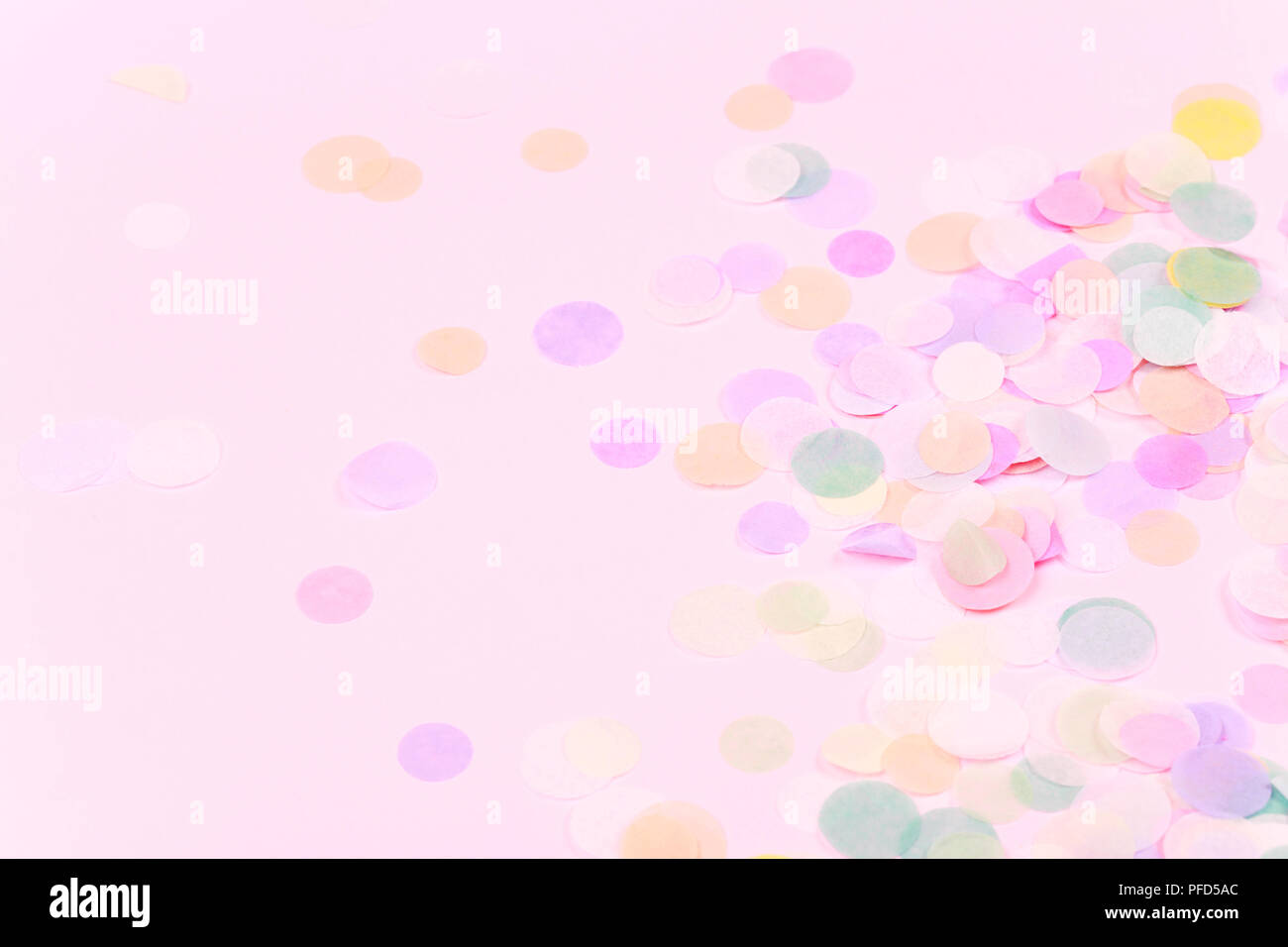 Vibrant confetti on pastel pink background Stock Photo - Alamy