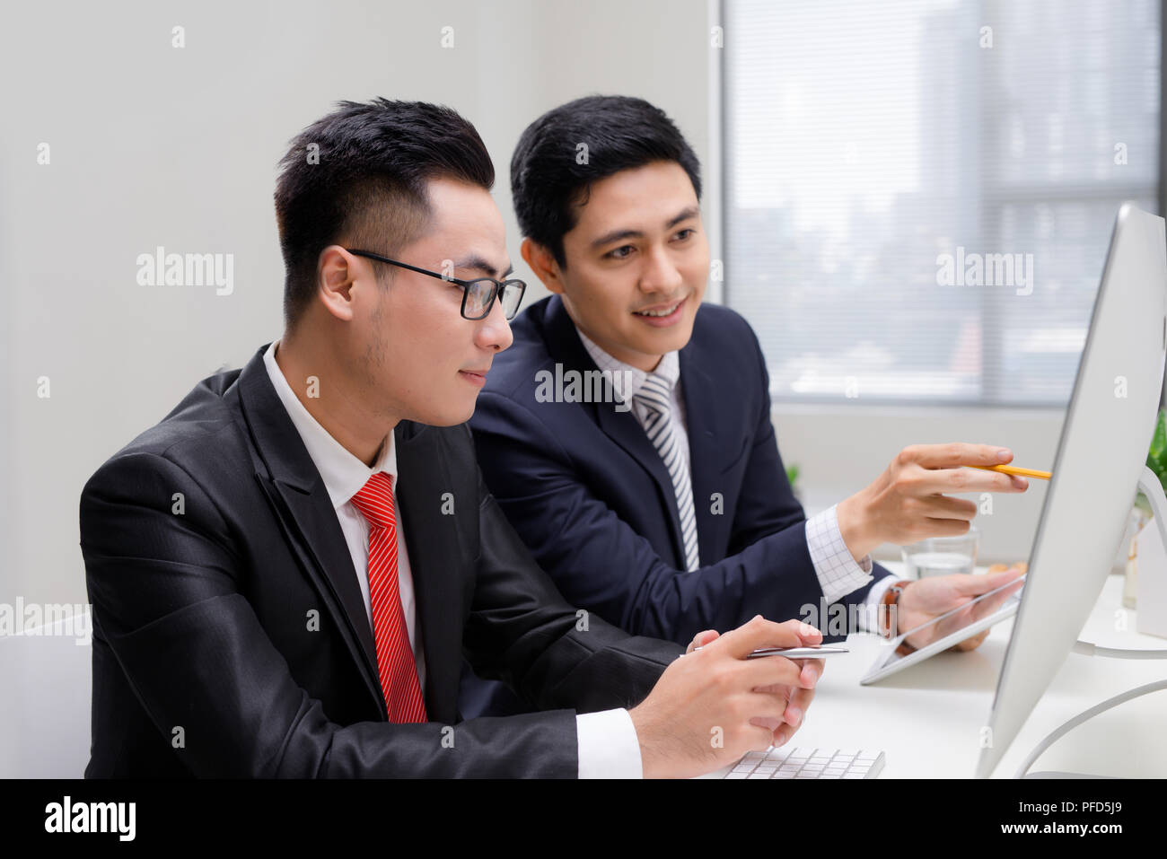 Startup business partners working together in desktop Stock Photo - Alamy