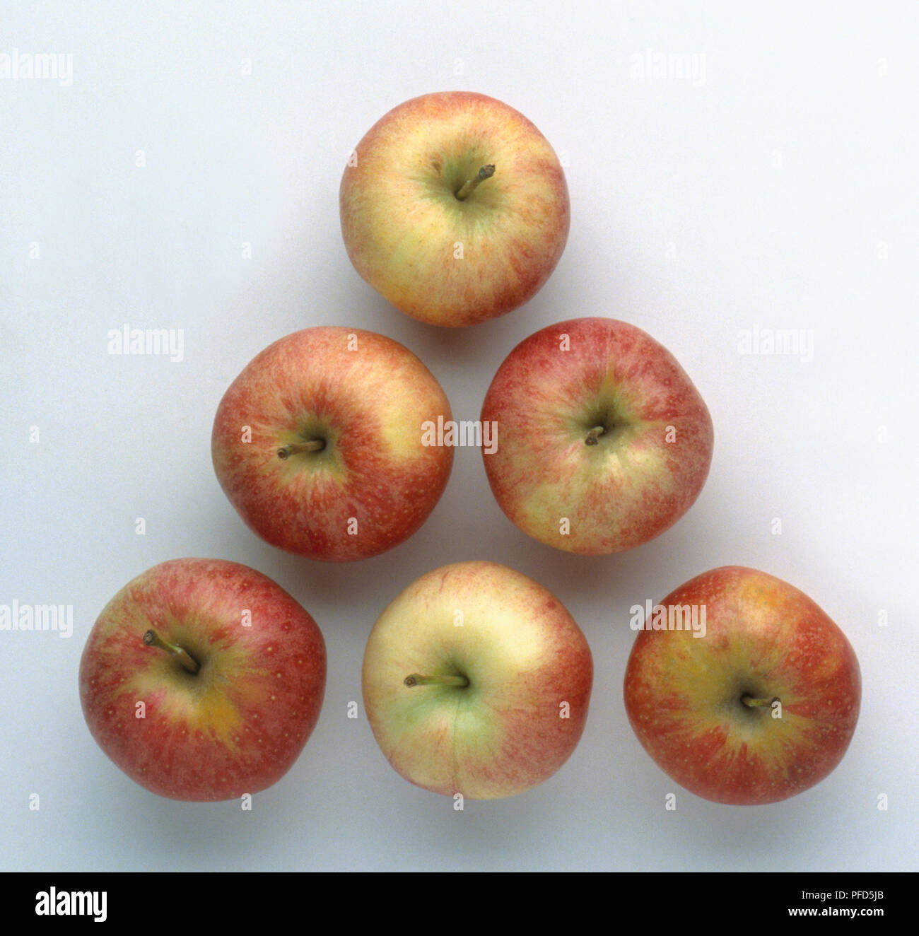 Six red and yellow apples forming a pyramid shape Stock Photo - Alamy