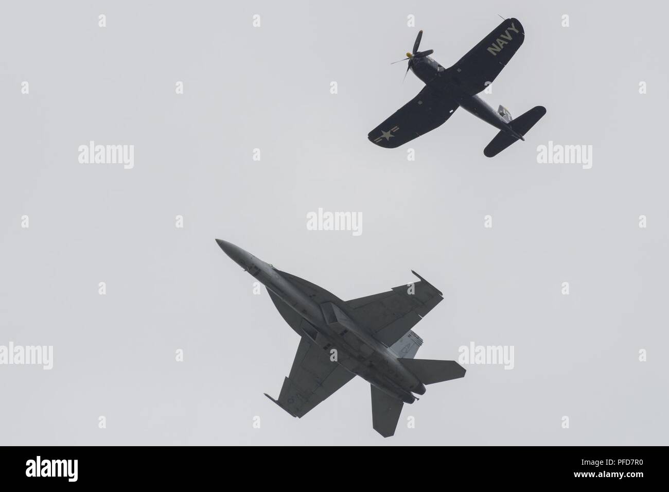 A U.S. Navy F-18 Super Hornet fighter jet and a former Navy F4U-4 ...