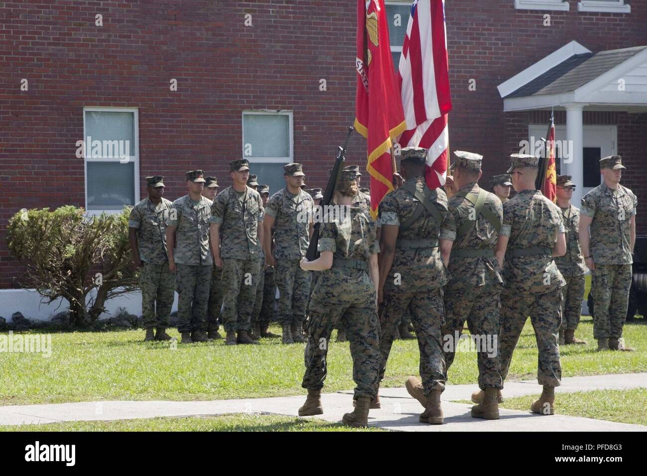The Weapons Training Battalion color guard marchs off the colors during ...