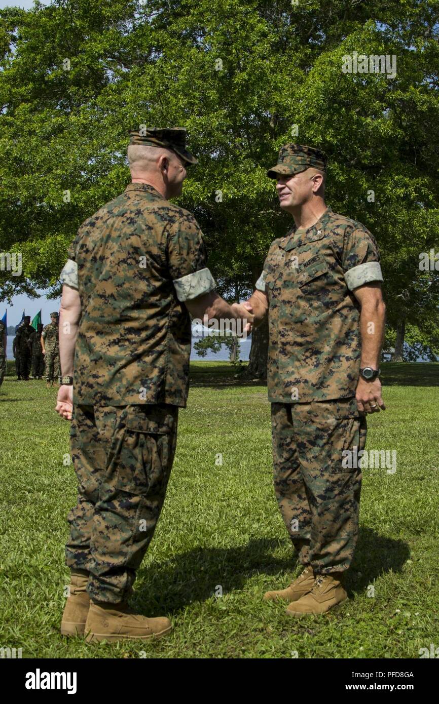Col. Michael J. Corrado, left, commanding officer, shakes hands with ...