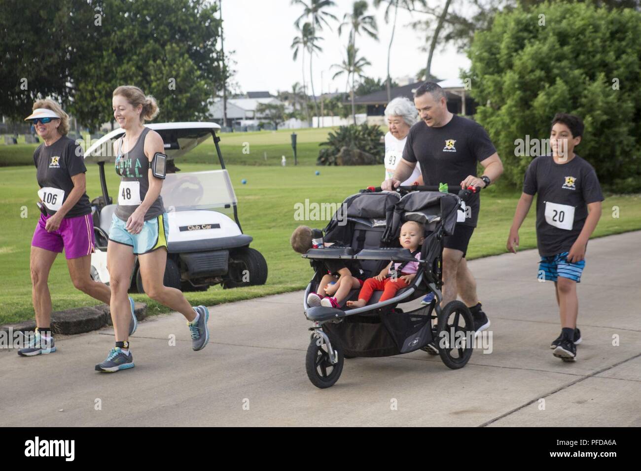 Race participants run through the Klipper Golf Course during the Surf N ...