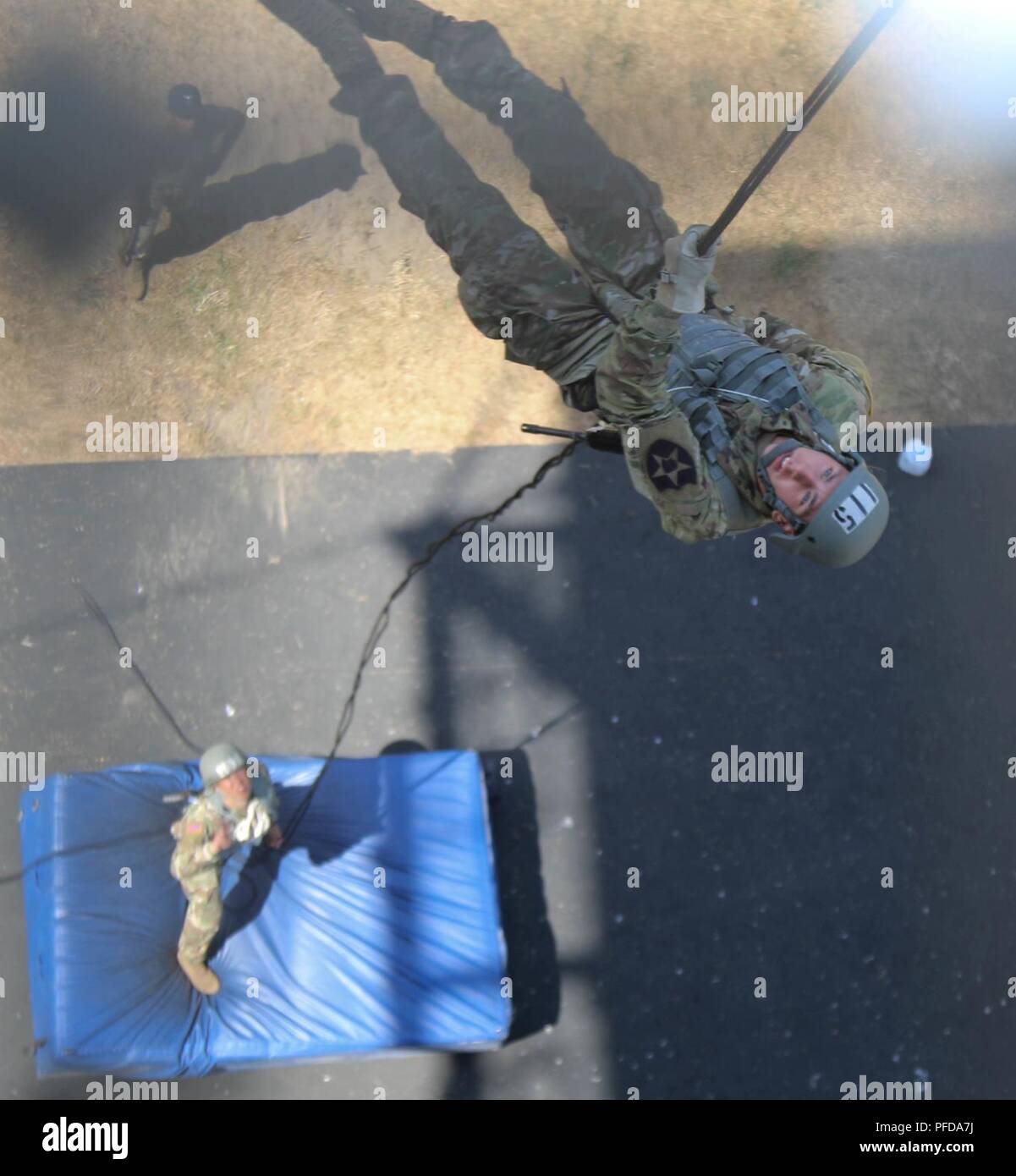 Soldiers and Airmen rappel from a 70-foot tower during the final phase ...