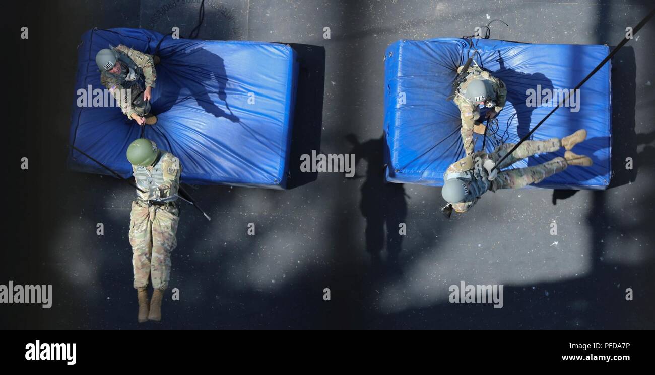 Soldiers and Airmen rappel from a 70-foot tower during the final phase ...