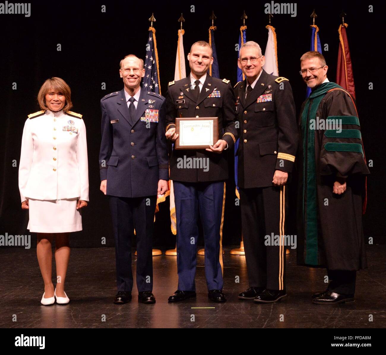 Army Maj. Tyson Sjulin, pulmonary/critical care fellow, receives the ...