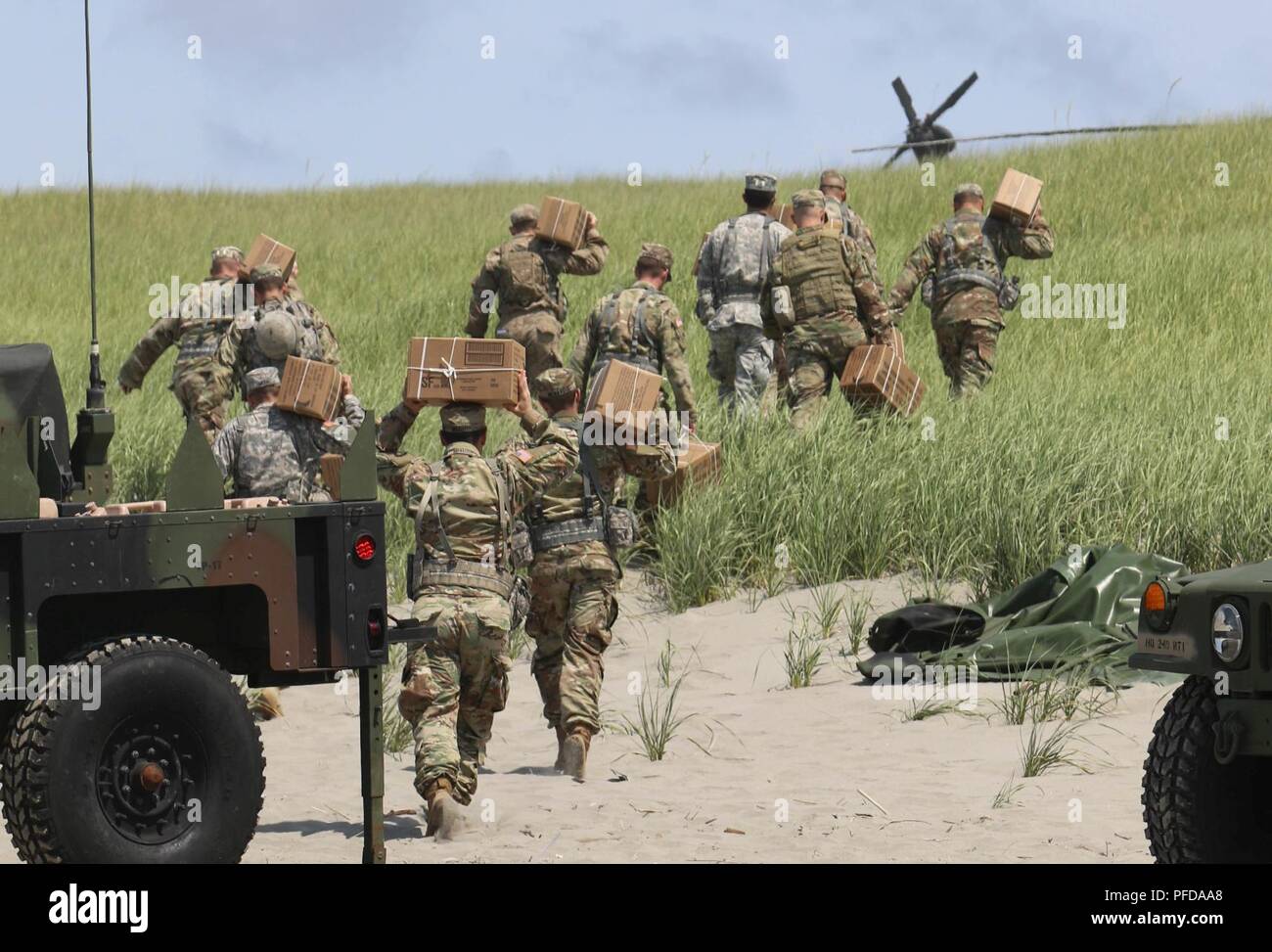 Soldiers haul ready-to-eat meals to a UH-60 Black Hawk helicopter ...