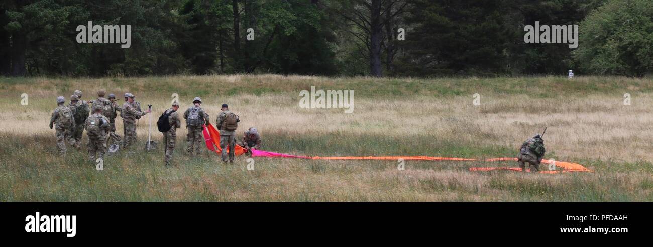 Soldiers lay out a drop zone marker indicating the area items being ...