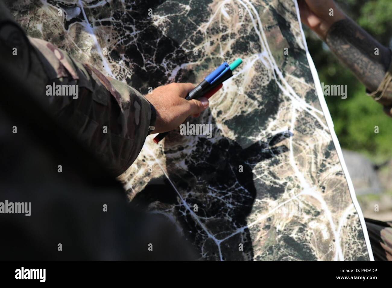 1st Lt. Matthew Aiton, 3rd Cavalry Regiment, Fort Hood, Texas, points ...