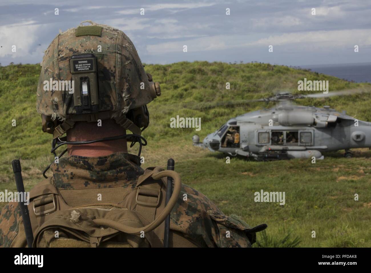 A Marine with 5th Air Naval Gunfire Liaison Company watches an MH-60S ...