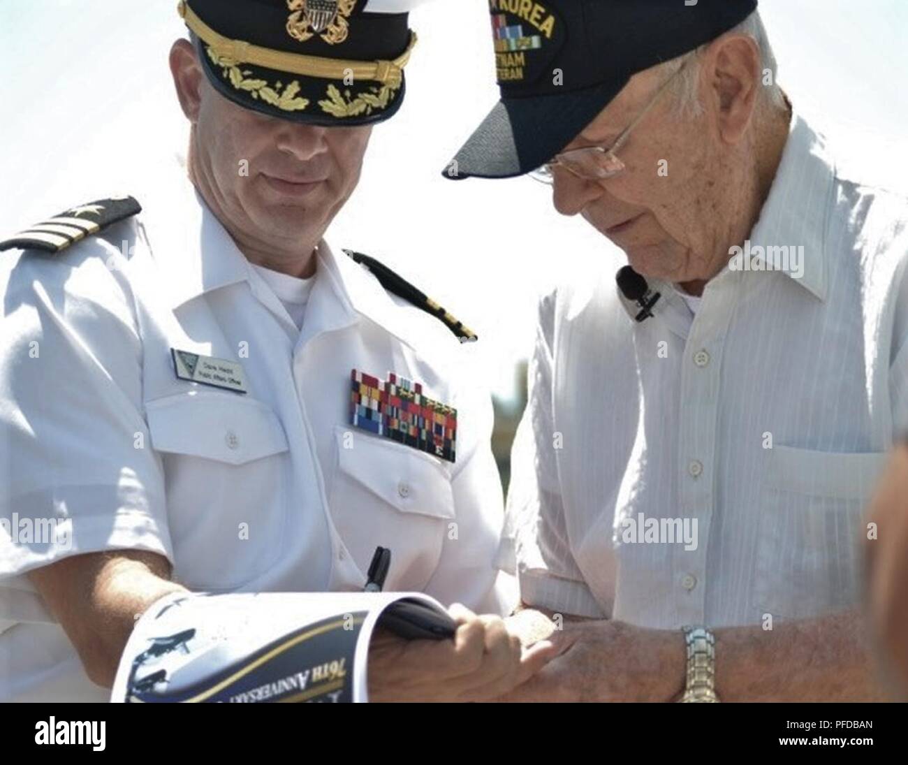 Commander David Hecht, PAO with Naval Air Forces-Atlantic, receives an ...