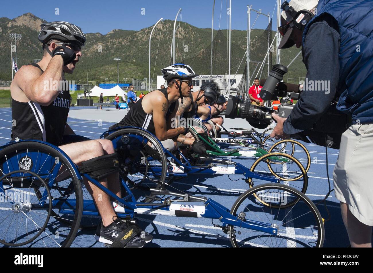 U.S. Army Staff Sgt. Shawn Runnells, left, cheers in front of a ...