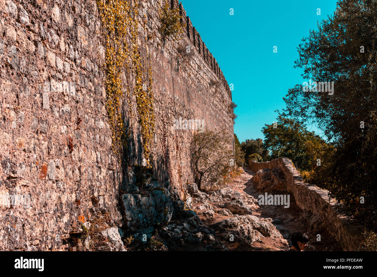 Rock path beside castle wall Stock Photo - Alamy