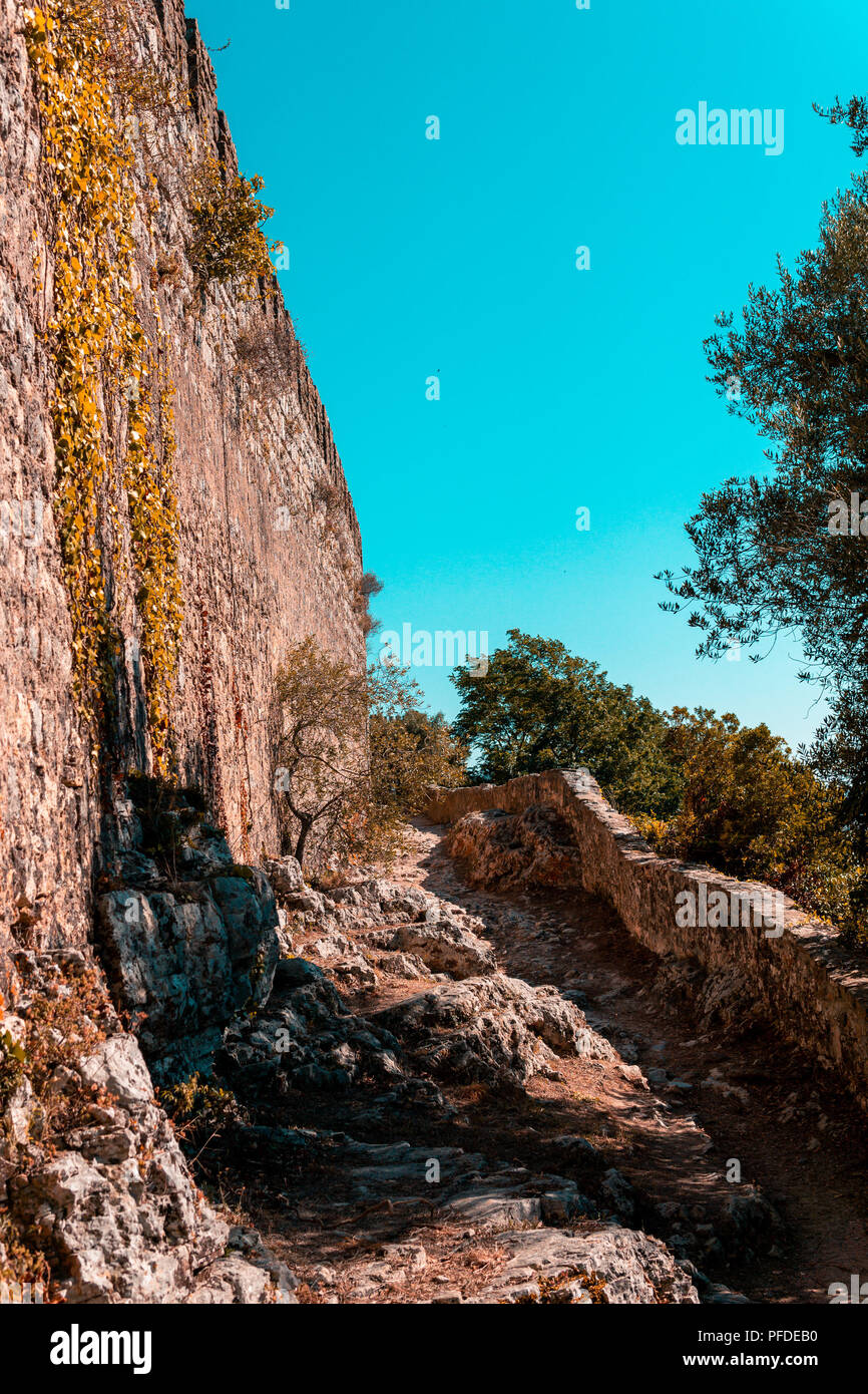 Rock path beside castle wall Stock Photo - Alamy
