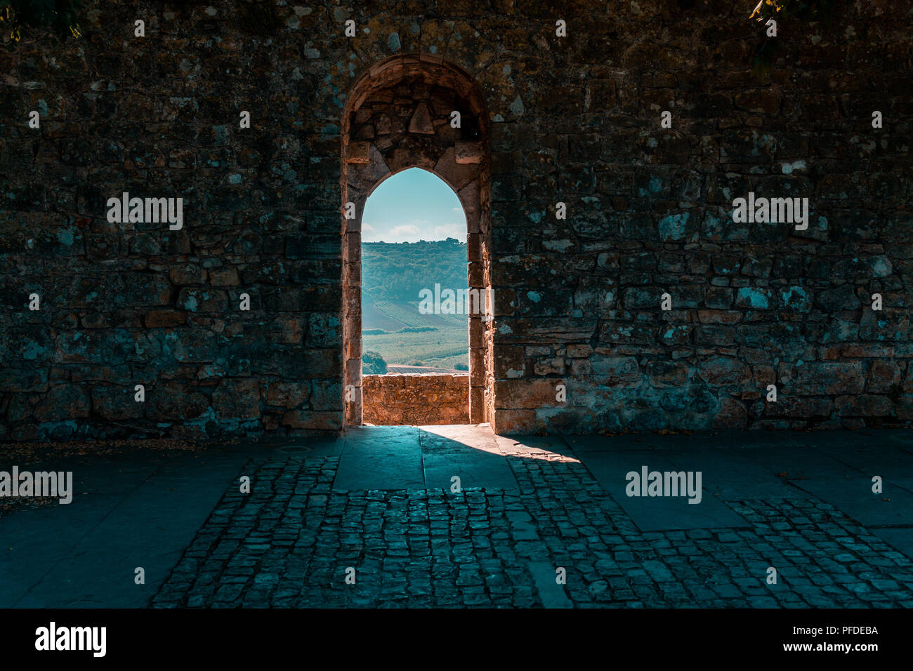 Perspective view through archway in castle wall Stock Photo - Alamy
