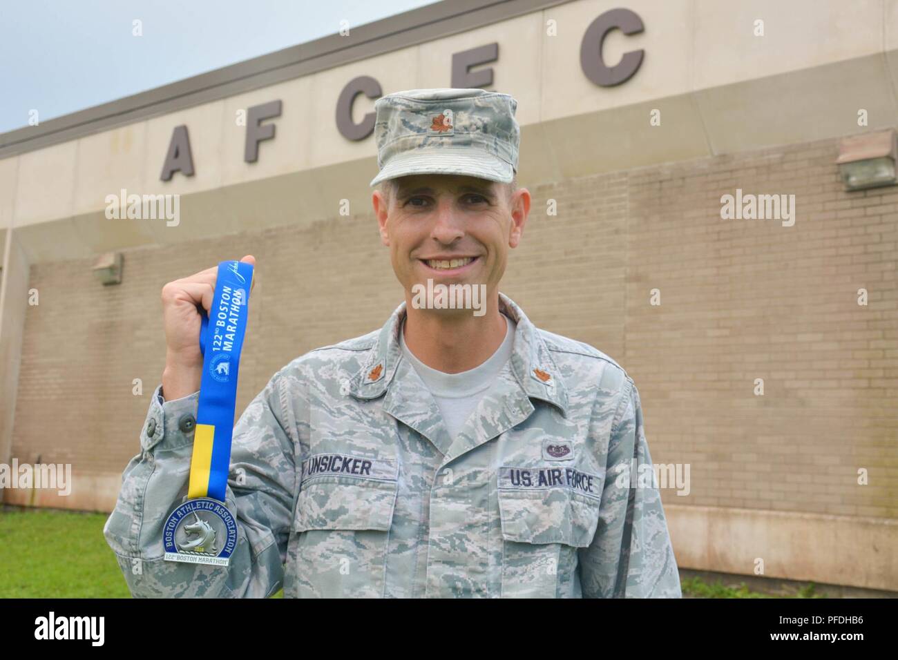 Major Andy Unsicker proudly displays the medal he received for ...