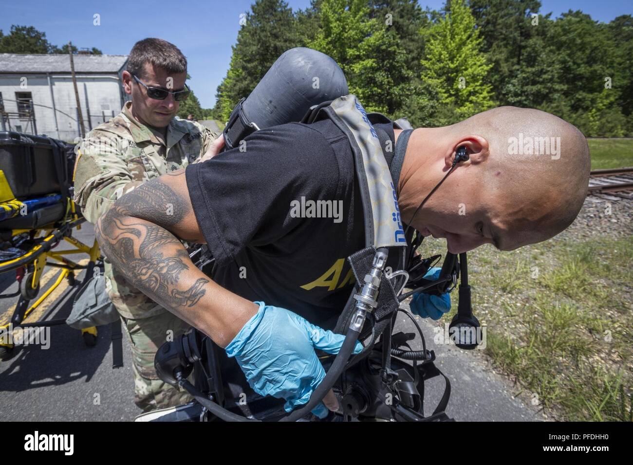 U.S. Army Sgt. 1st Class Steve B. Kovacs, left, helps survey team ...