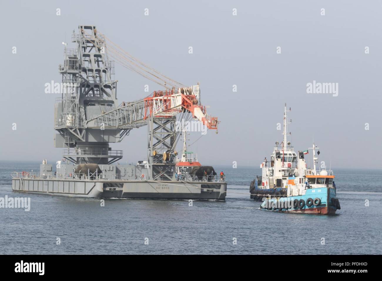 SHUAIBA PORT, Kuwait – Kuwaiti tugboats assist in pulling the Barge ...