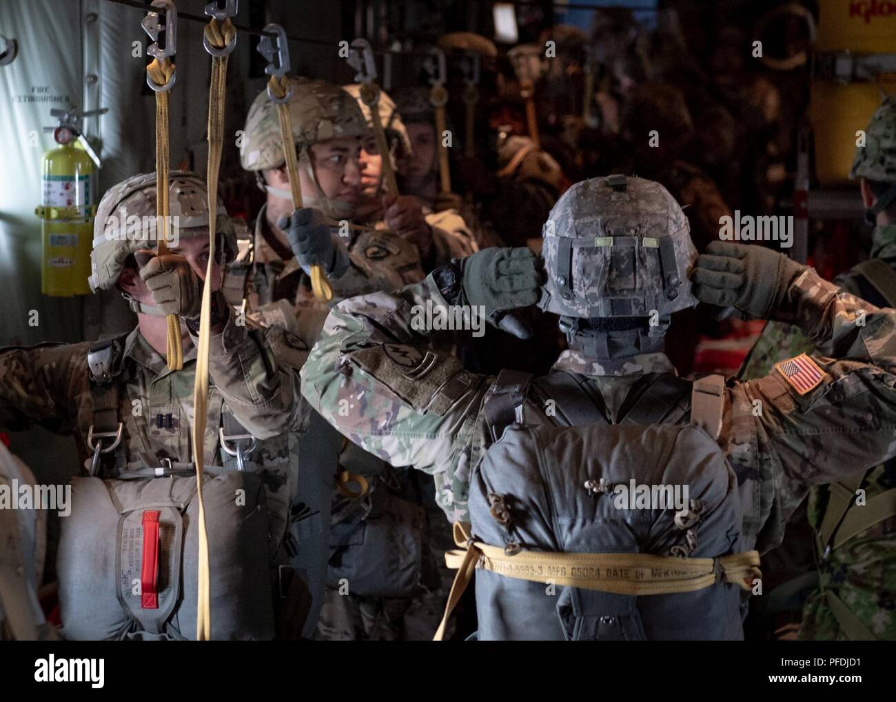 A U.S. Army jumpmaster signals paratroopers of the incoming drop zone ...