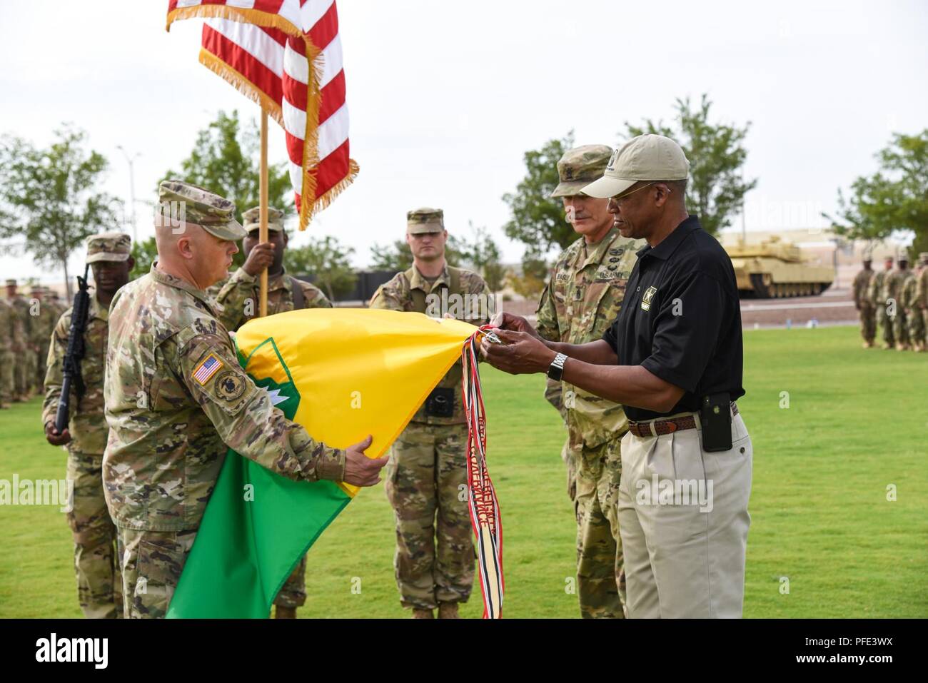 Retired Maj. Gen. Augustus Collins adds a streamer on the 155th Armored ...