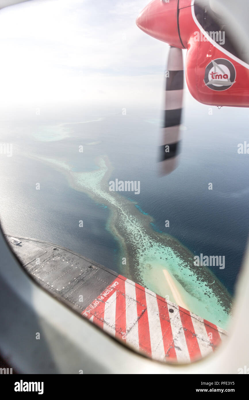 The aerial view from a seaplane in the ocean lagoon of Maldives ...