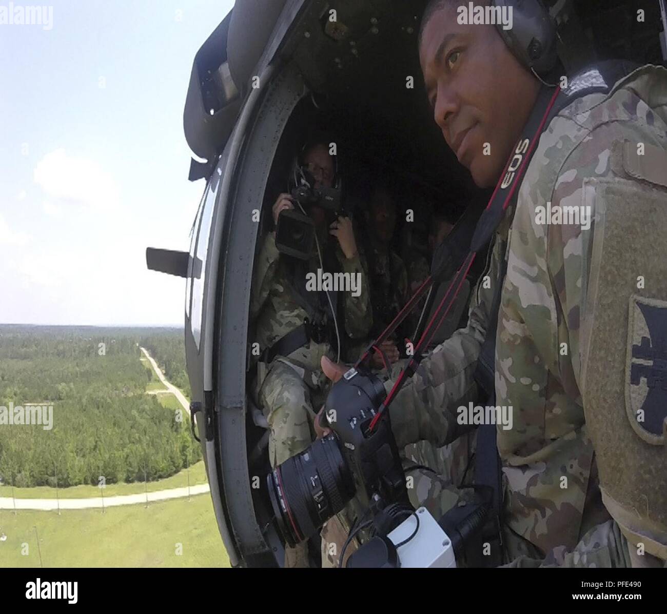 Sgt. 1st Class Jeremy Reed looks on as he records the terrain below ...