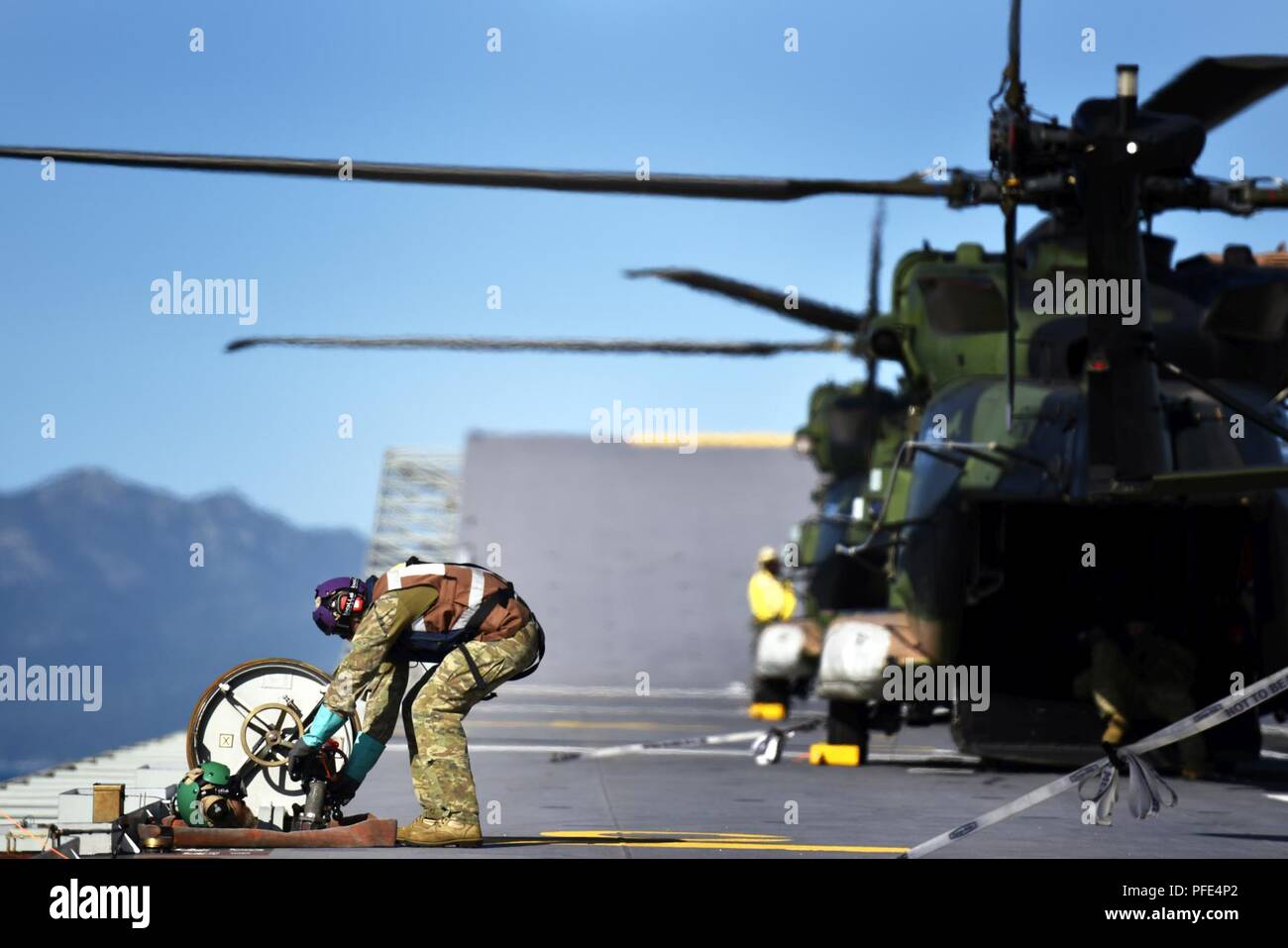 Members of the Australian Regular Army work on the flight deck to ...