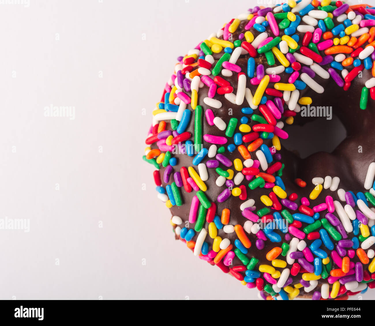 Half doughnut with multicolored sprinkles on a white background Stock ...