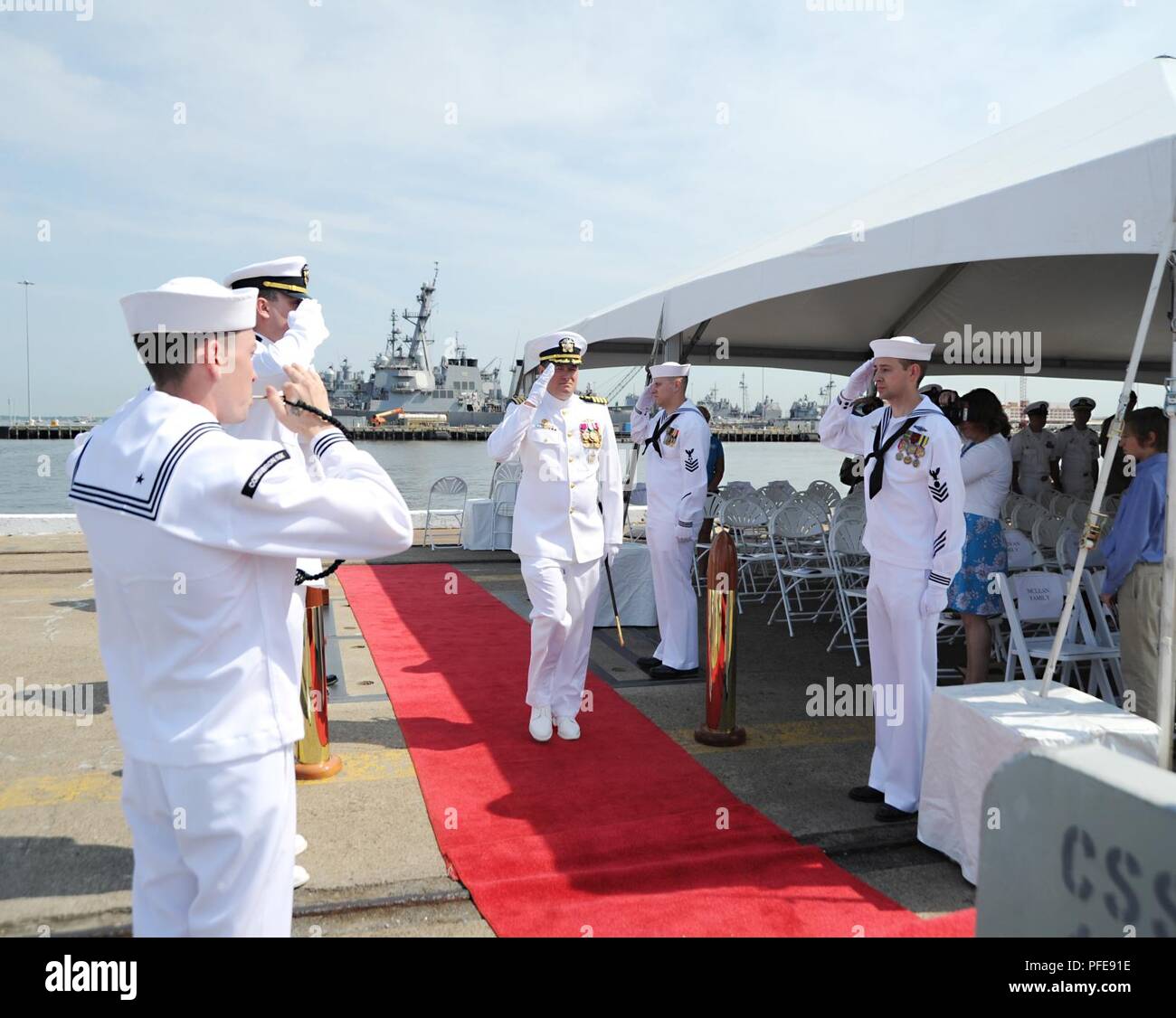 Boatswain’s Mate Second Class Brandon Nobles, assigned to Submarine Squadron Six, pipes the side ...