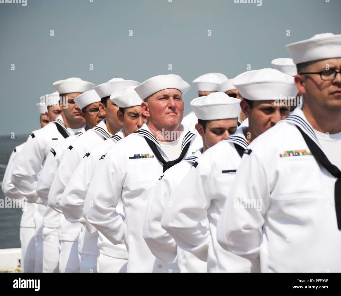Sailors stand in formation during the change of command ceremony for ...