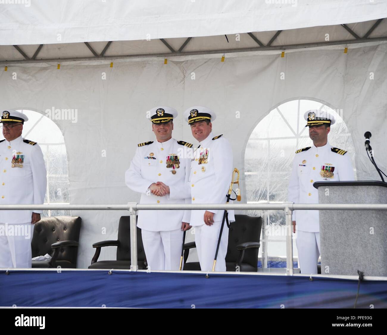 Capt. Carl Hartsfield, commander, Submarine Squadron Six, presents Cmdr ...