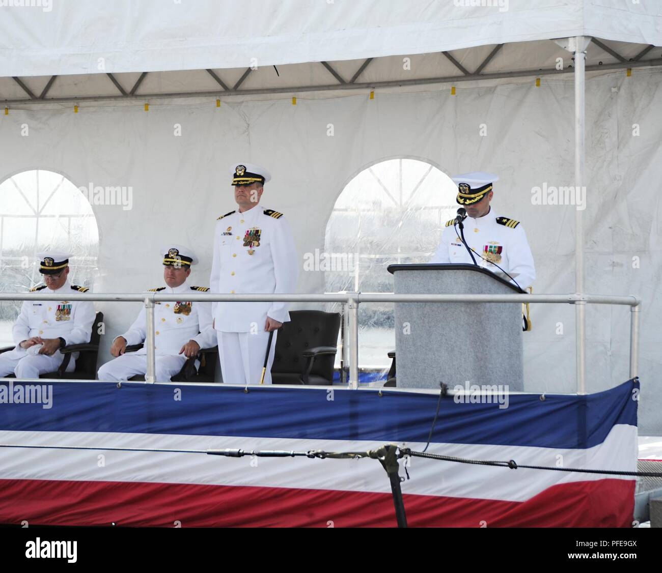 Cmdr. Kristopher Lancaster reads his orders before assuming command of ...