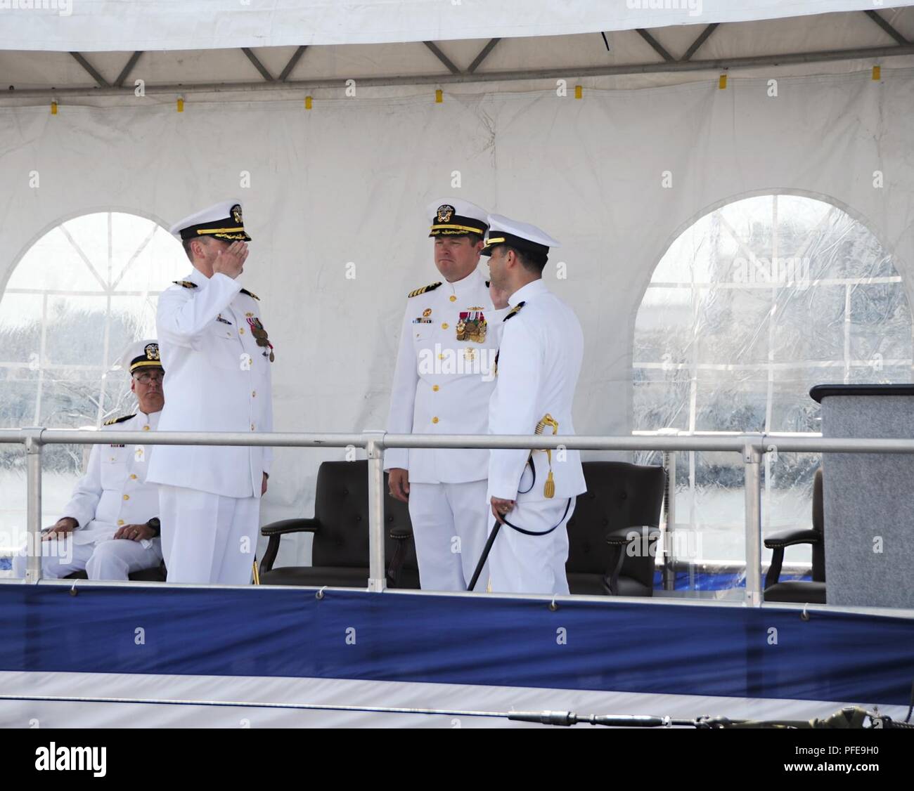 Cmdr. Kristopher Lancaster returns a salute to Cmdr. Christopher Osborn ...