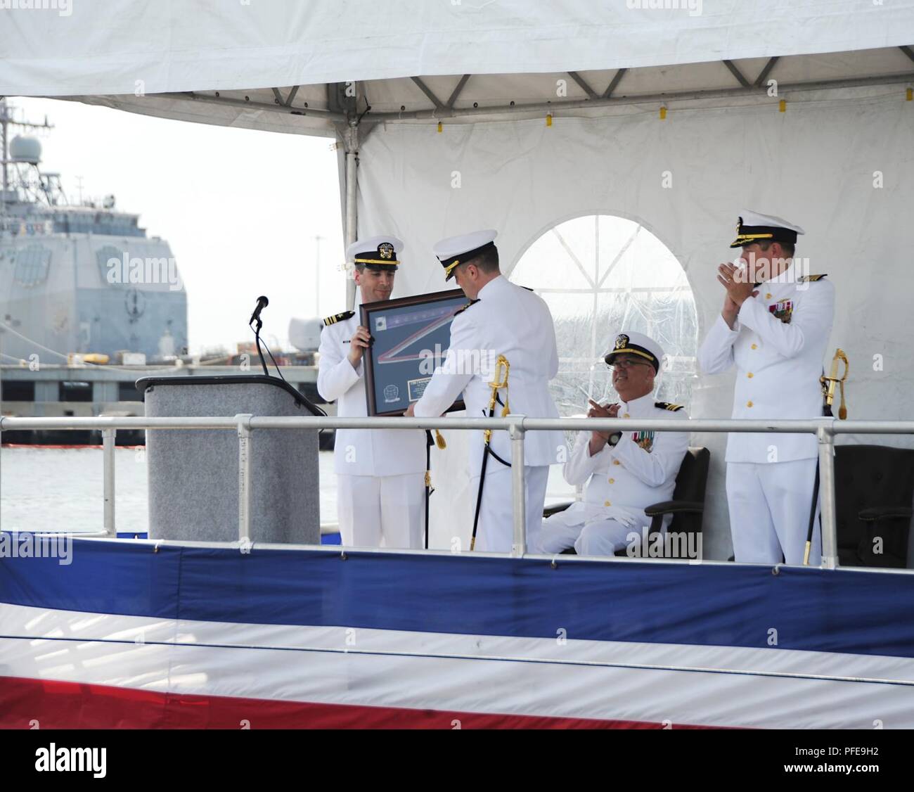 Lt. Cmdr. Matthew Brouillard, executive officer USS Boise, presents ...
