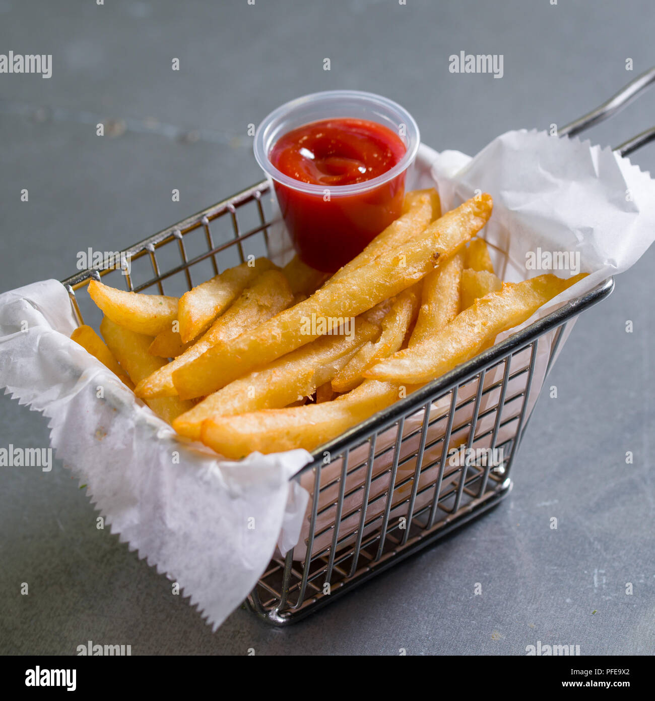 French fries in a steel basket on a table Stock Photo - Alamy
