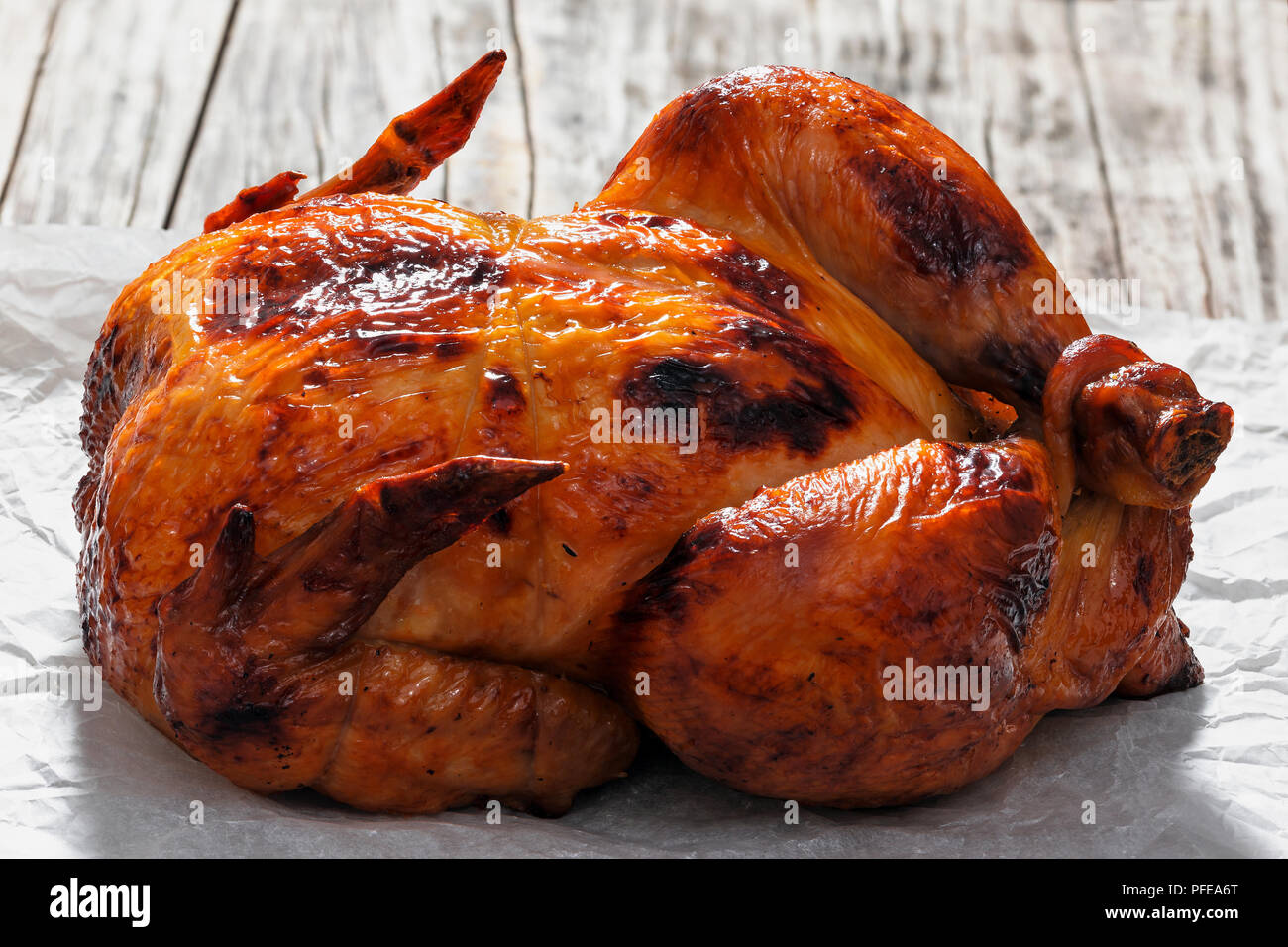 delicious whole chicken roasted in oven on parchment paper on old ...