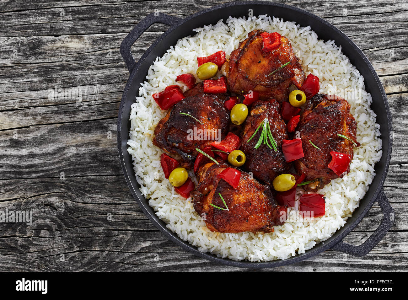 rice with grilled chicken thighs, red bell pepper, green olive and ...