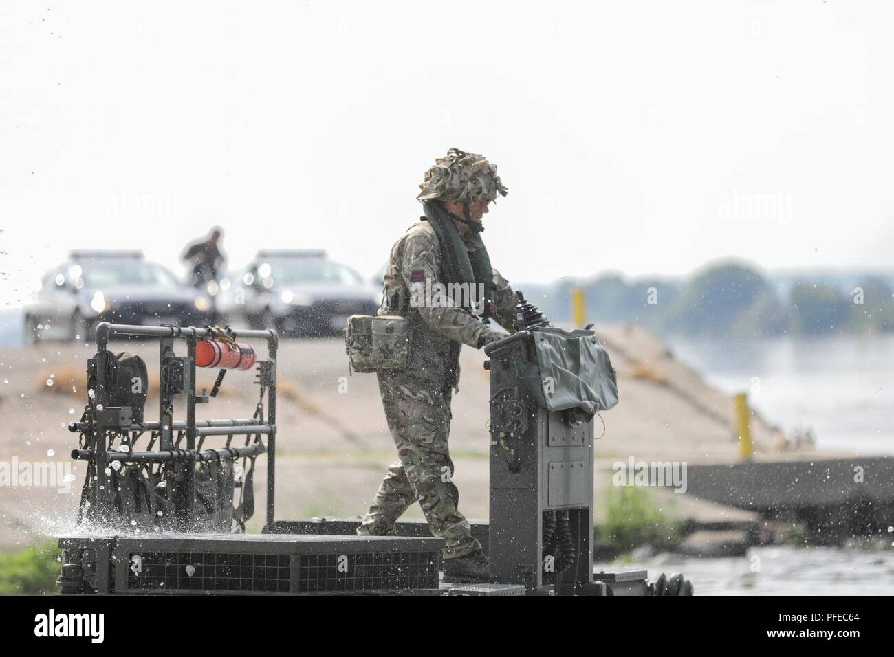 A British Royal Army Soldier navigates an amphibious asset across a wet ...
