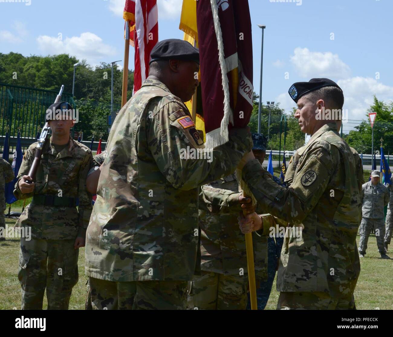U.S. Army Command Sgt. Major Clark Charpentier, right, passes the ...