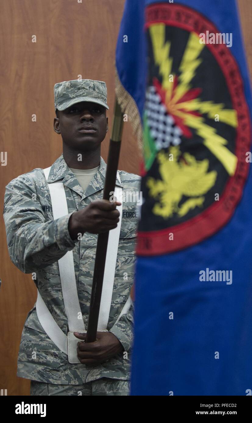 A member of a U.S. Joint Military Honor Guard team posts the colors ...