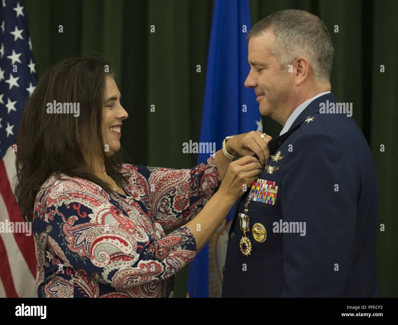 Leslie Butikofer fastens the retirement pin on Brig. Gen. Mitchel ...