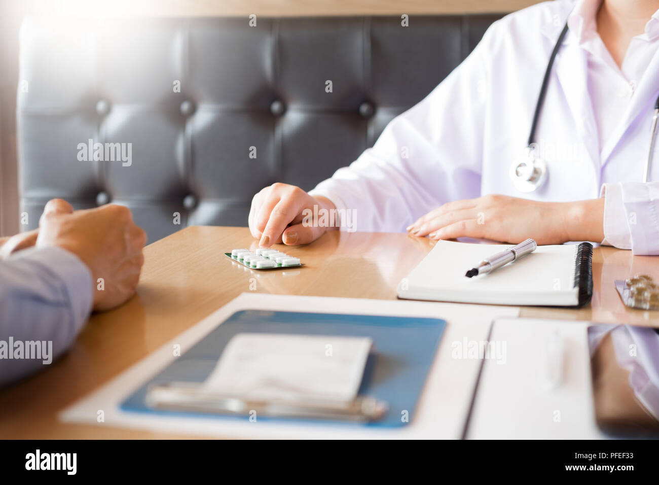 doctor hand holding tablet of drug and explain to patient in hospital ...