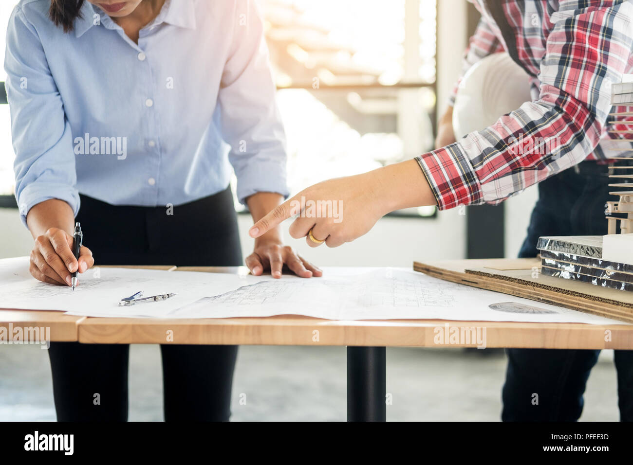 Close-up Of Person's engineer Hand Drawing Plan On Blue Print with ...