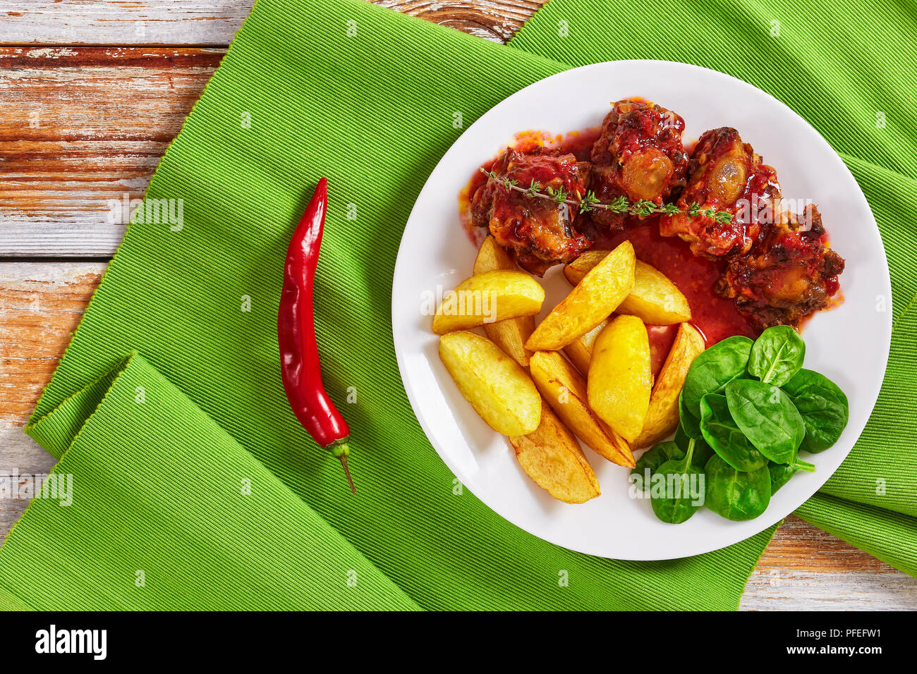 rabo de toro or oxtail stewed in red wine tomato sauce on white plate ...