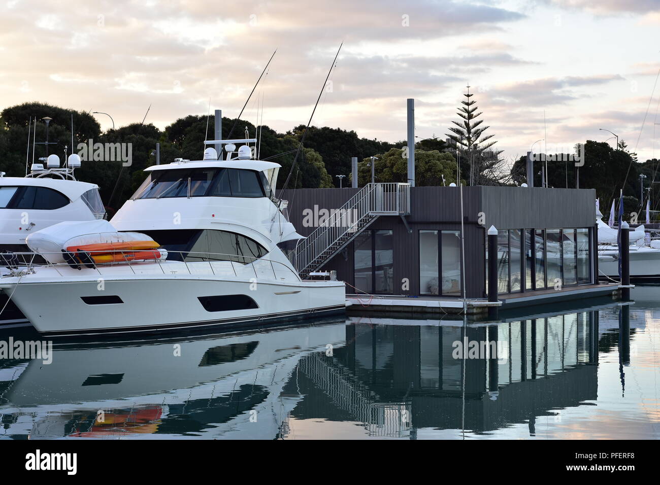 Large motor yachts in marina next to floating office building on very ...